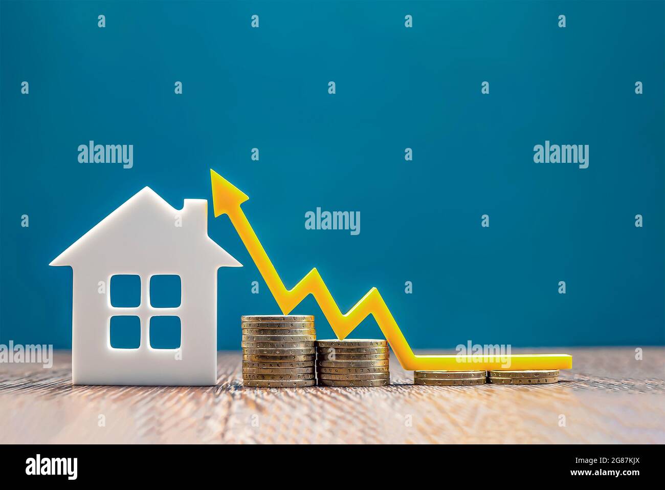 Real estate market, graph, up arrow. House model and a stack of coins ...
