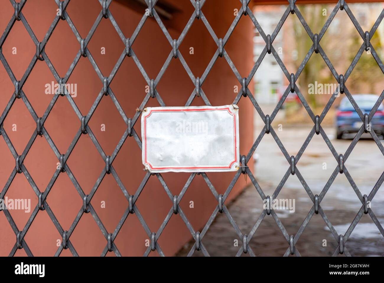 Blank warning sign on the black gate. Private gate. Space for text ...