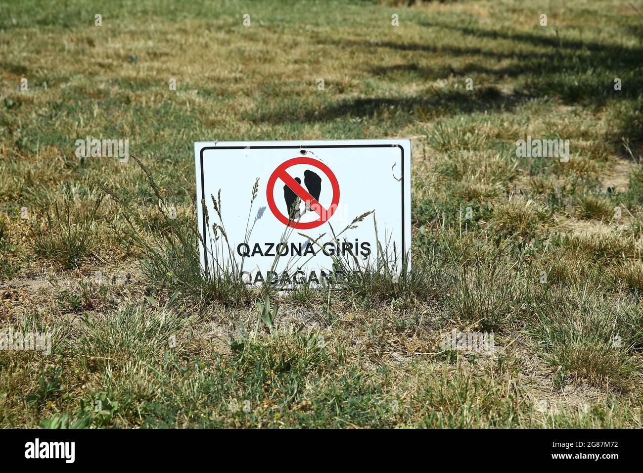 Signboard with the symbol don't walk on the grass . Road stop sign ...