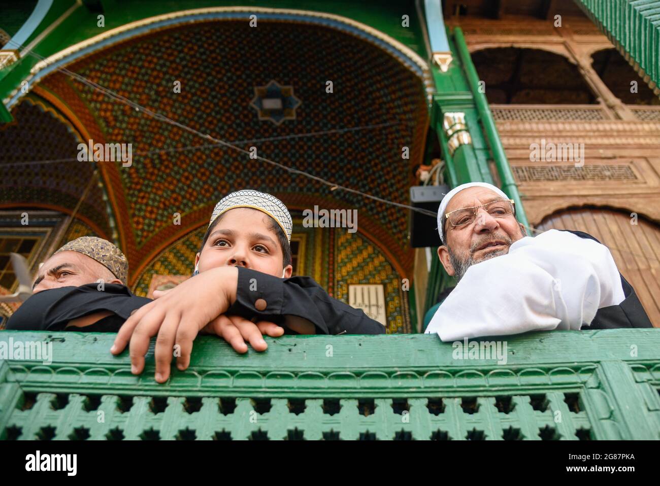 A Kashmiri boy with his grandfather look on from the shrine of Sufi ...