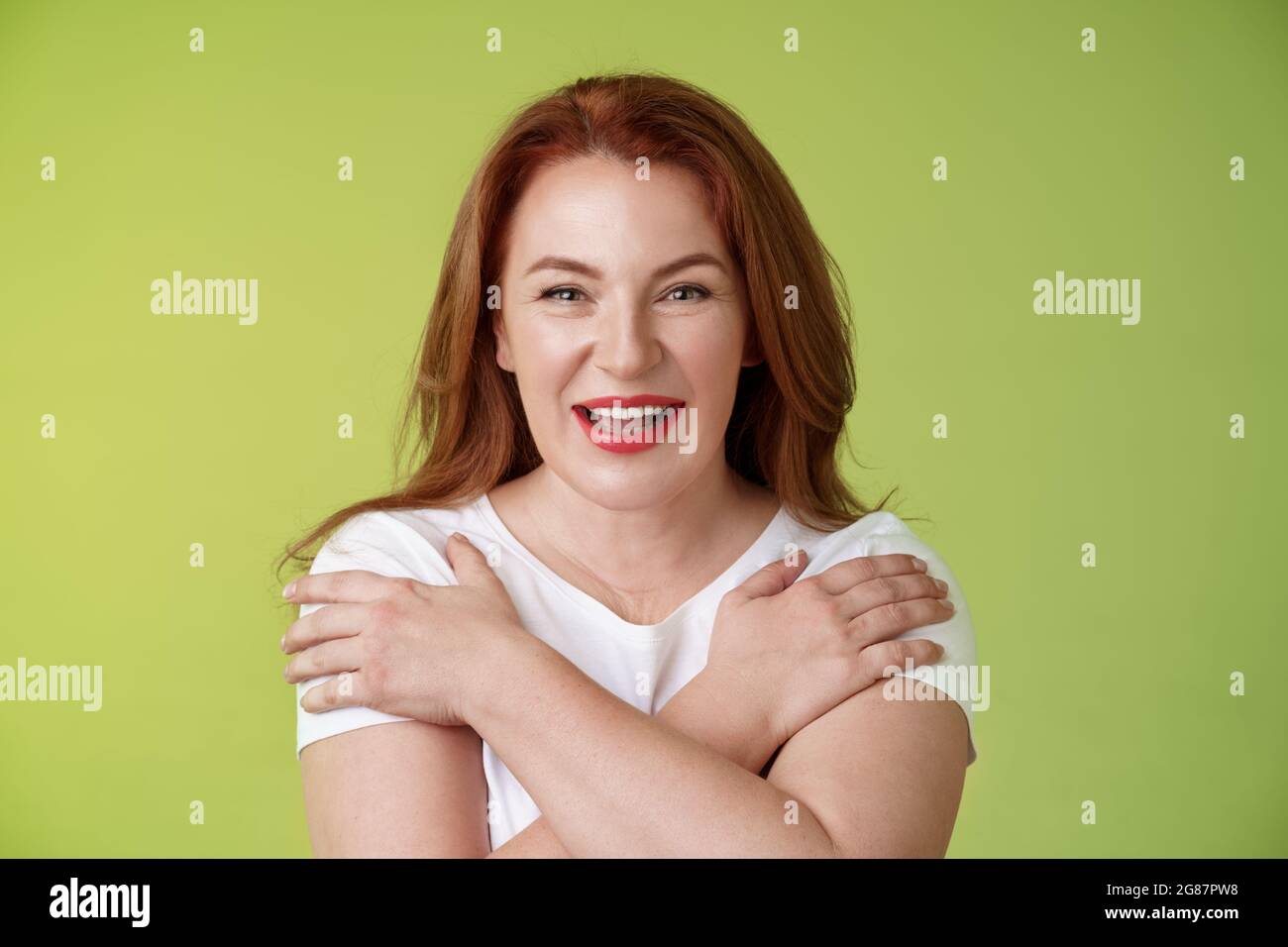 Cheerful charismatic happy good-looking redhead woman red lipstick ...