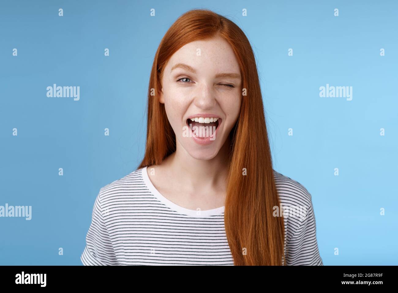 Cheeky good-looking flirty young gorgeous redhead girlfriend winking ...