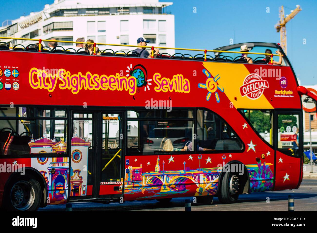 Seville Spain July 09, 2021 Tourist bus driving through the streets of ...