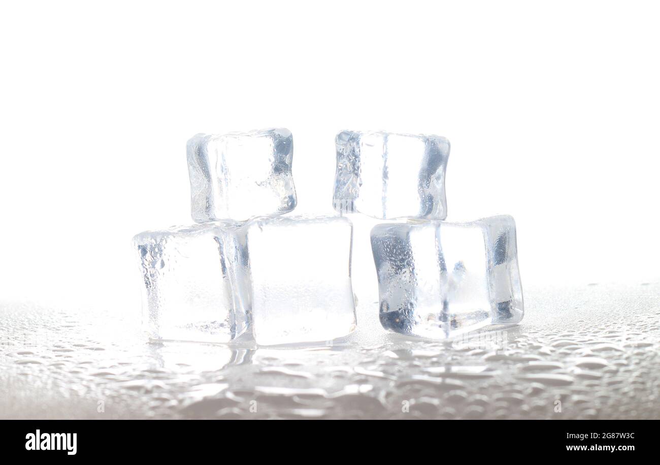 5 wet artificial or fake ice cube at white background Stock Photo - Alamy