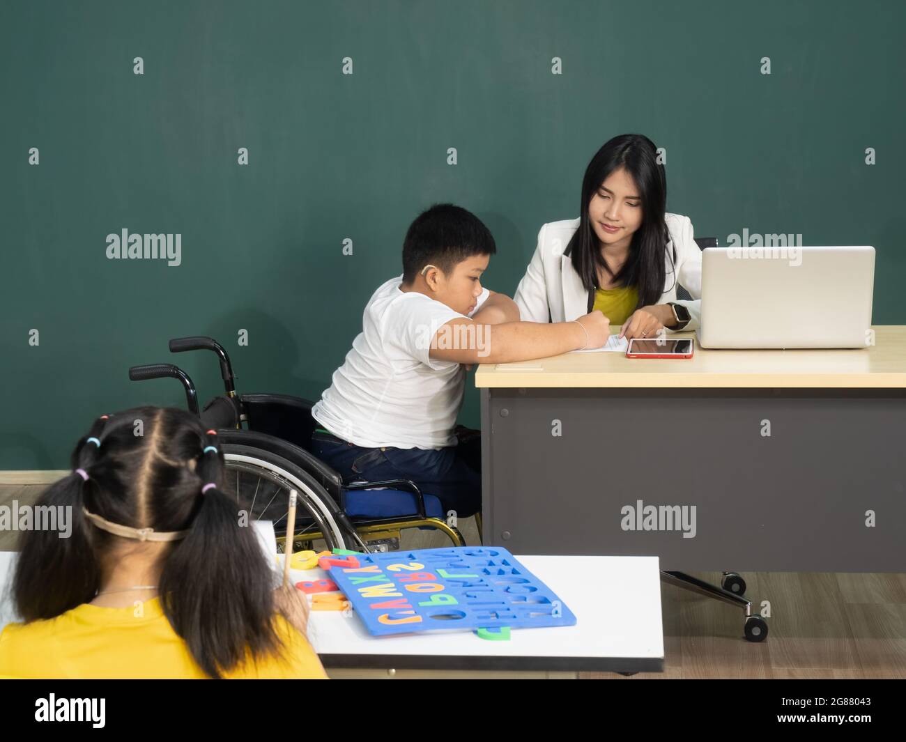 Spacial classroom of disabled kids or autism child learning and ...