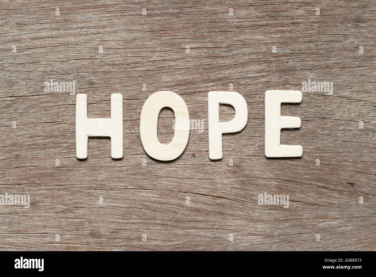 Alphabet letter in word hope on wood background Stock Photo - Alamy
