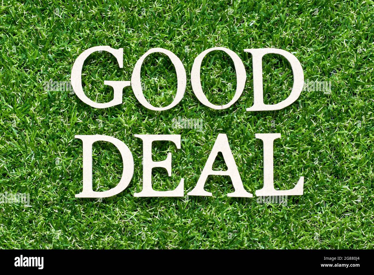 Wood alphabet letter in word good deal on artificial green grass ...