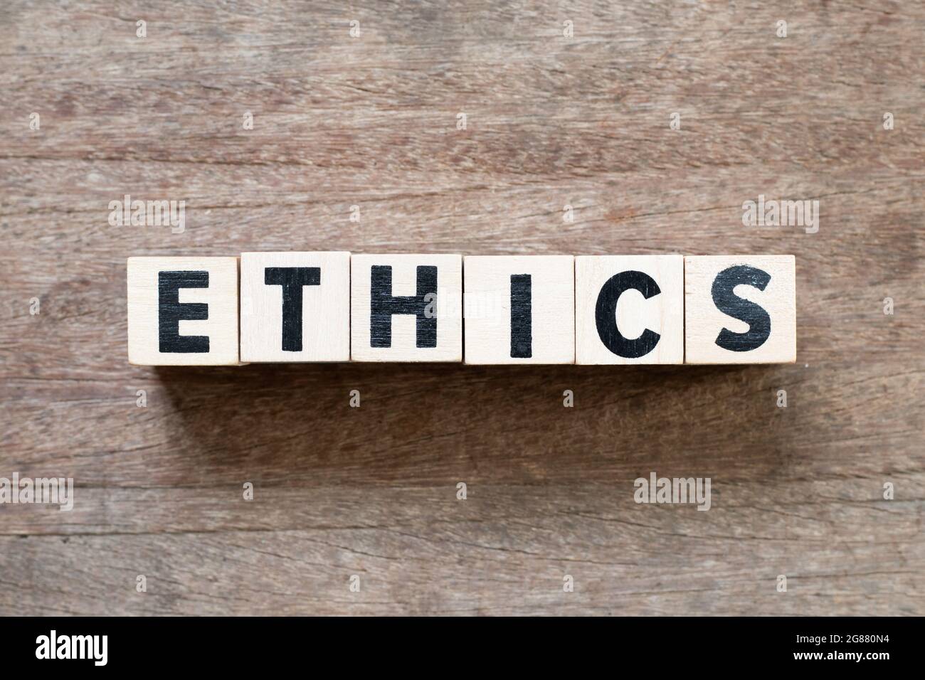 Letter block in word ethics on wood background Stock Photo - Alamy