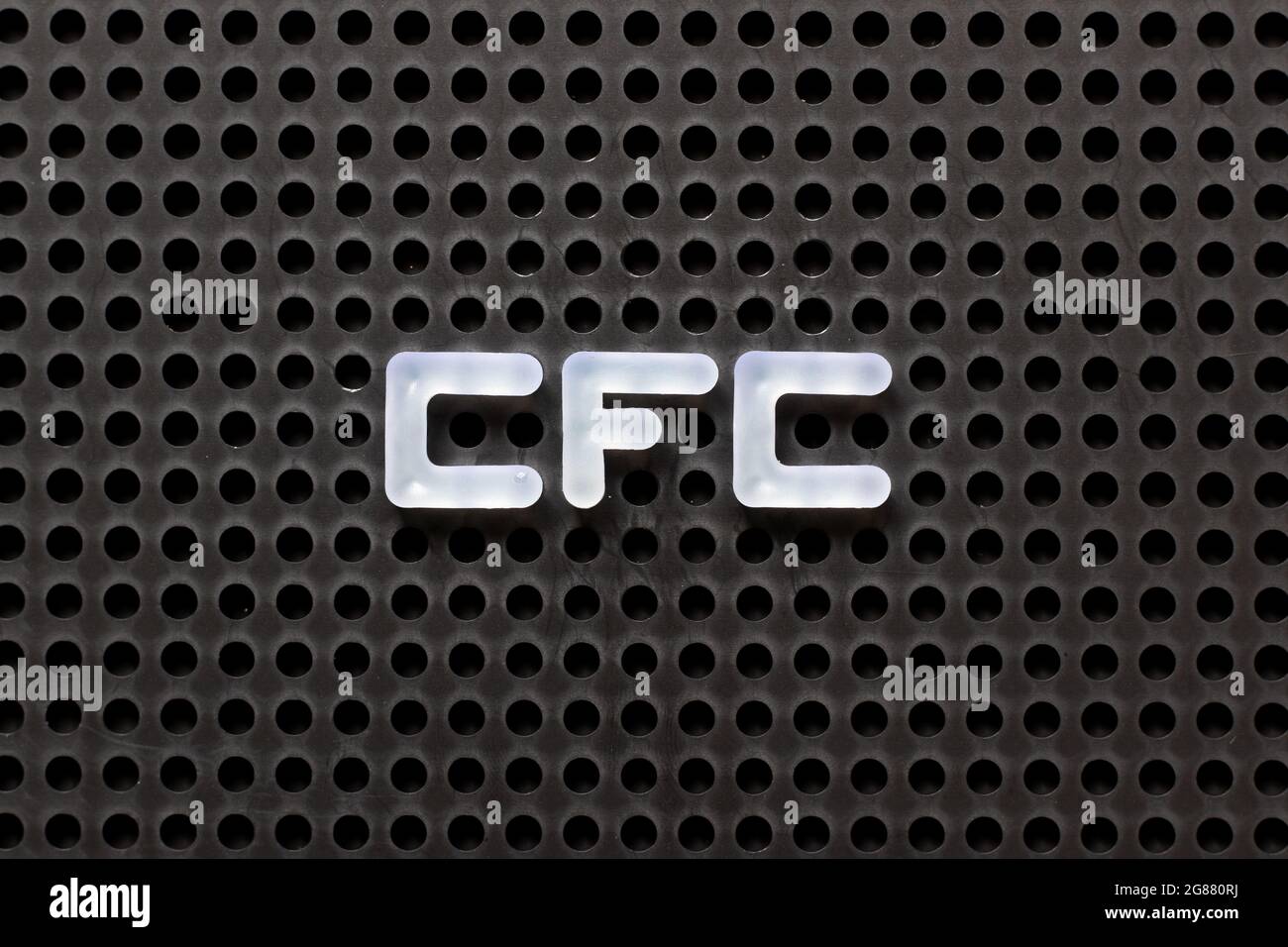 Black color pegboard with white letter in word CFC (abbreviation of ...