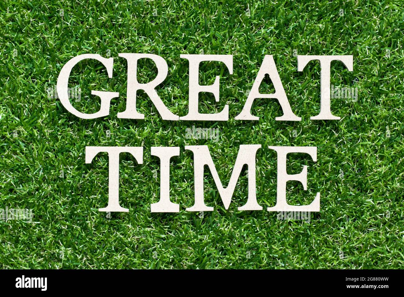 Wood alphabet letter in word great time on artificial green grass ...
