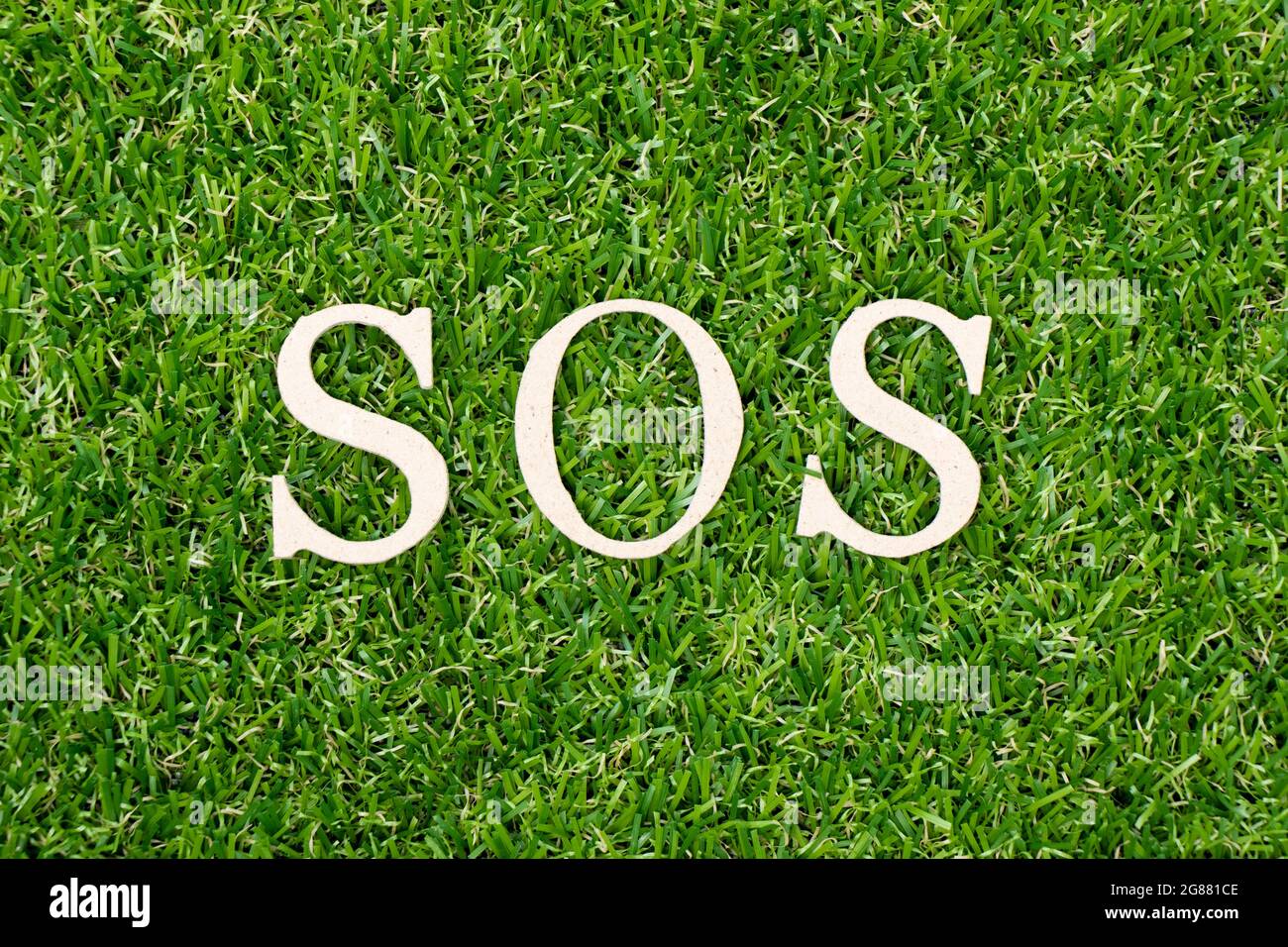 Wood letter in word SOS (abbreviation of save our soul/ship or sibling ...