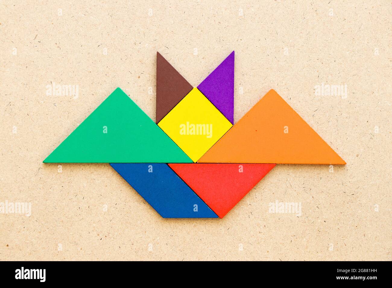 Color tangram in flying bat shape on wood background Stock Photo - Alamy