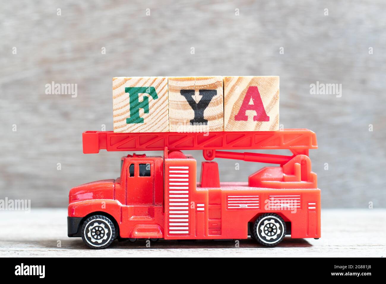 Red fire truck hold letter block in word FYA (Abbreviation of For your ...