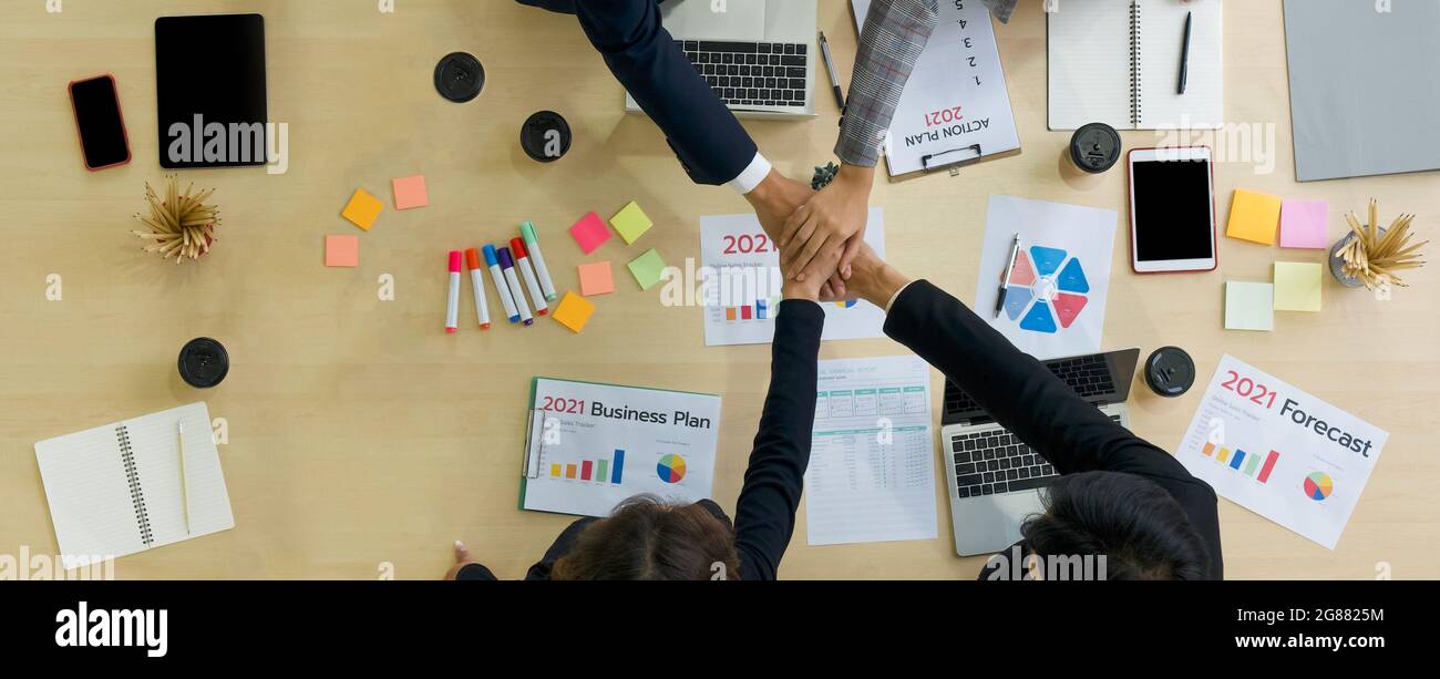 Business partners join hands in the modern office. Business executives ...