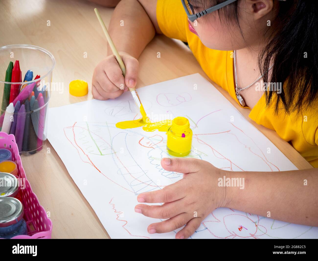 The cute little girl down syndrome learning about drawing and painting ...