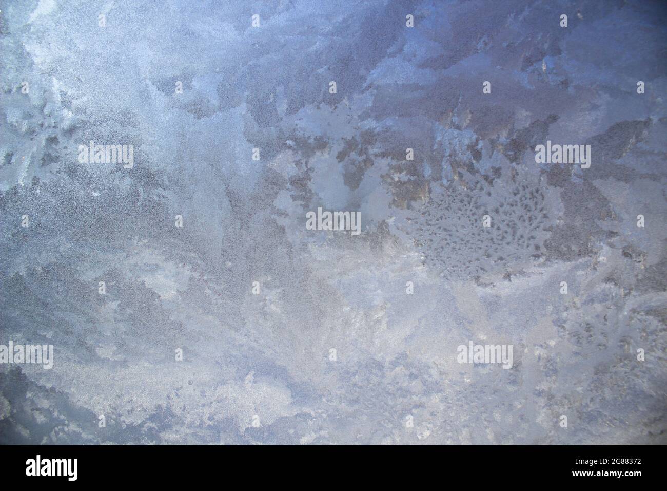 Textured frost patterns on the glass. Ice crystals on the window on a ...