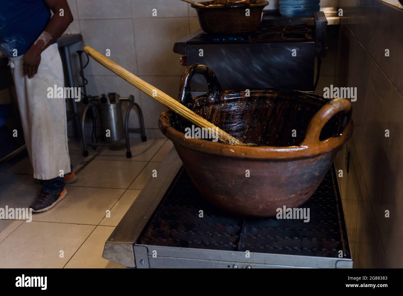 cooking Mexican Mole food in a traditional clay pot in Mexico Stock ...