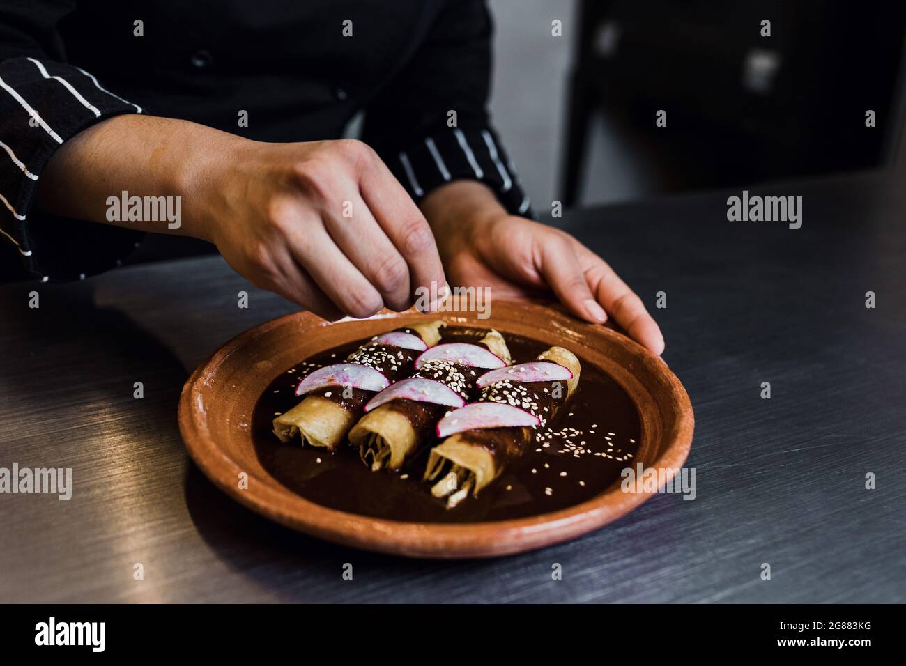 Latin woman chef cooking traditional mexican food in a restaurant ...