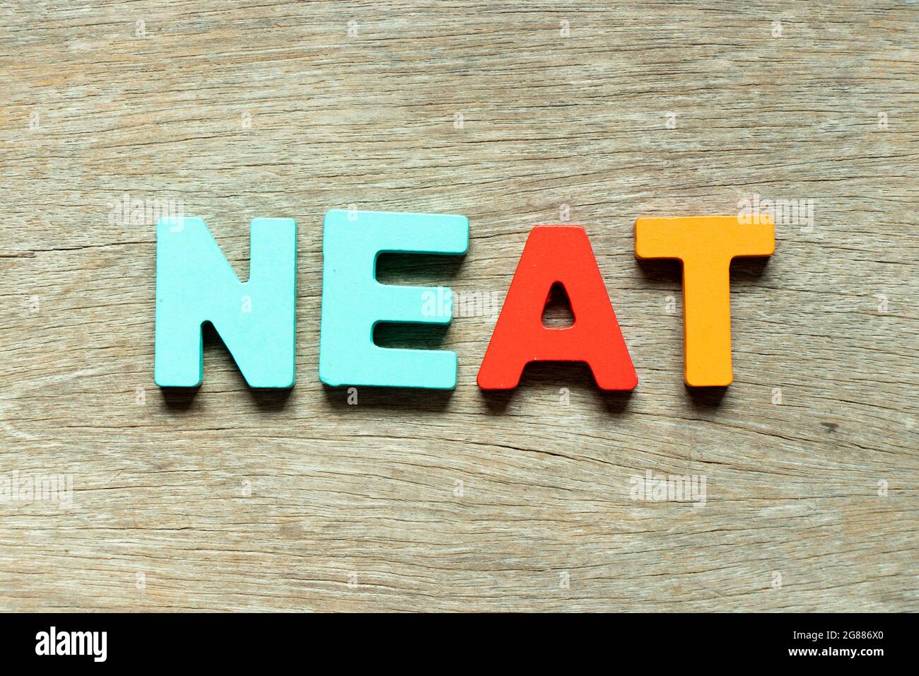 Color alphabet letter in word neat on wood background Stock Photo - Alamy