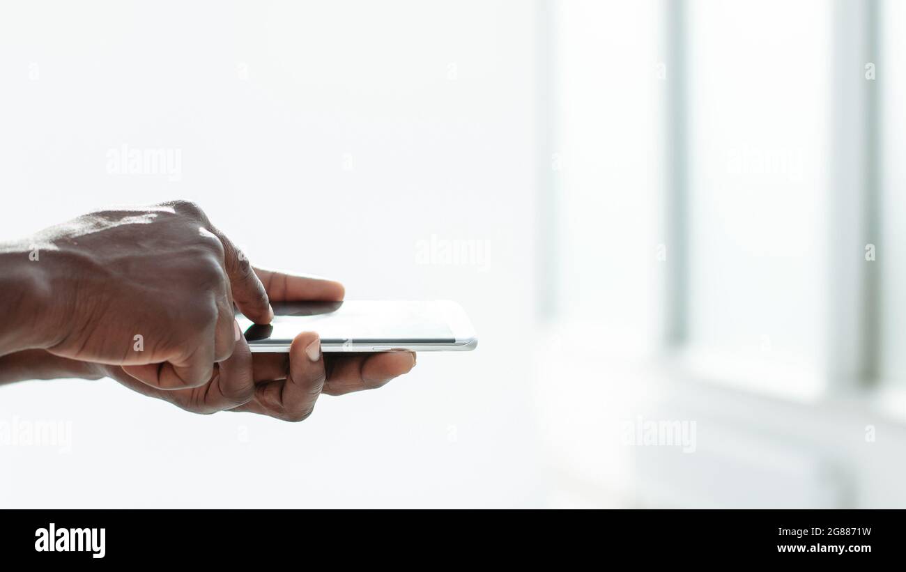 close up. young man typing SMS on his smartphone. photo with copy space ...