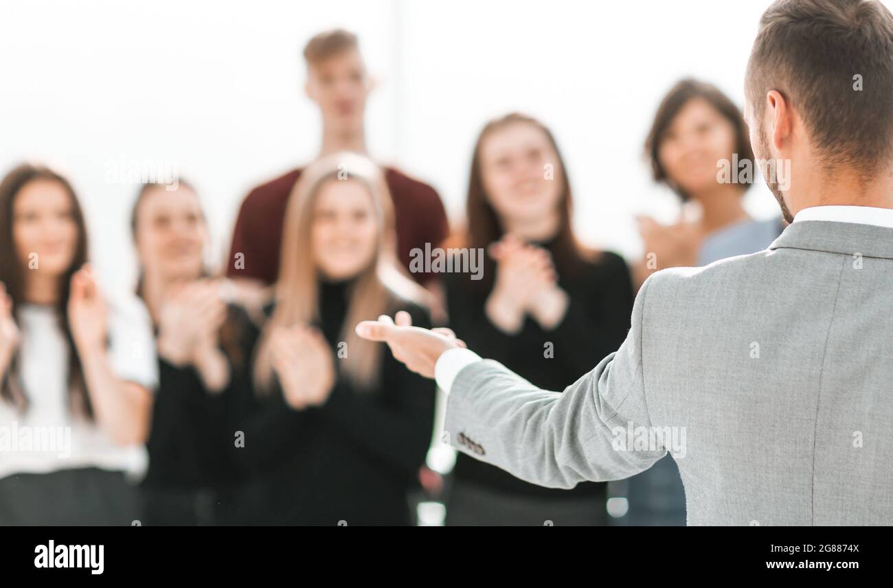 blurry image of a group of different people standing in a conference ...