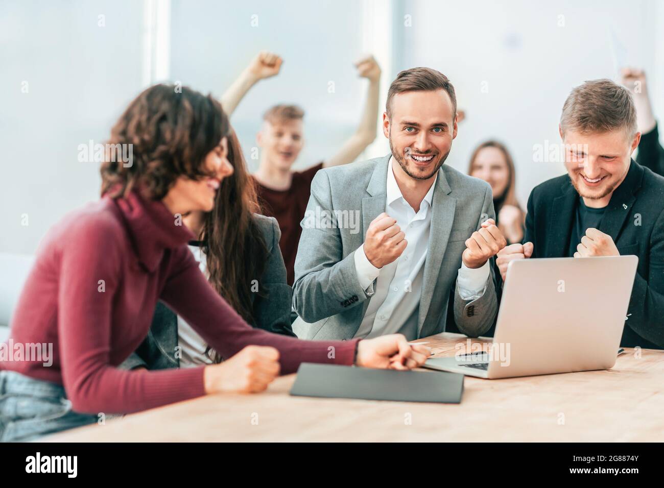 happy team of employees looking at laptop screen Stock Photo - Alamy