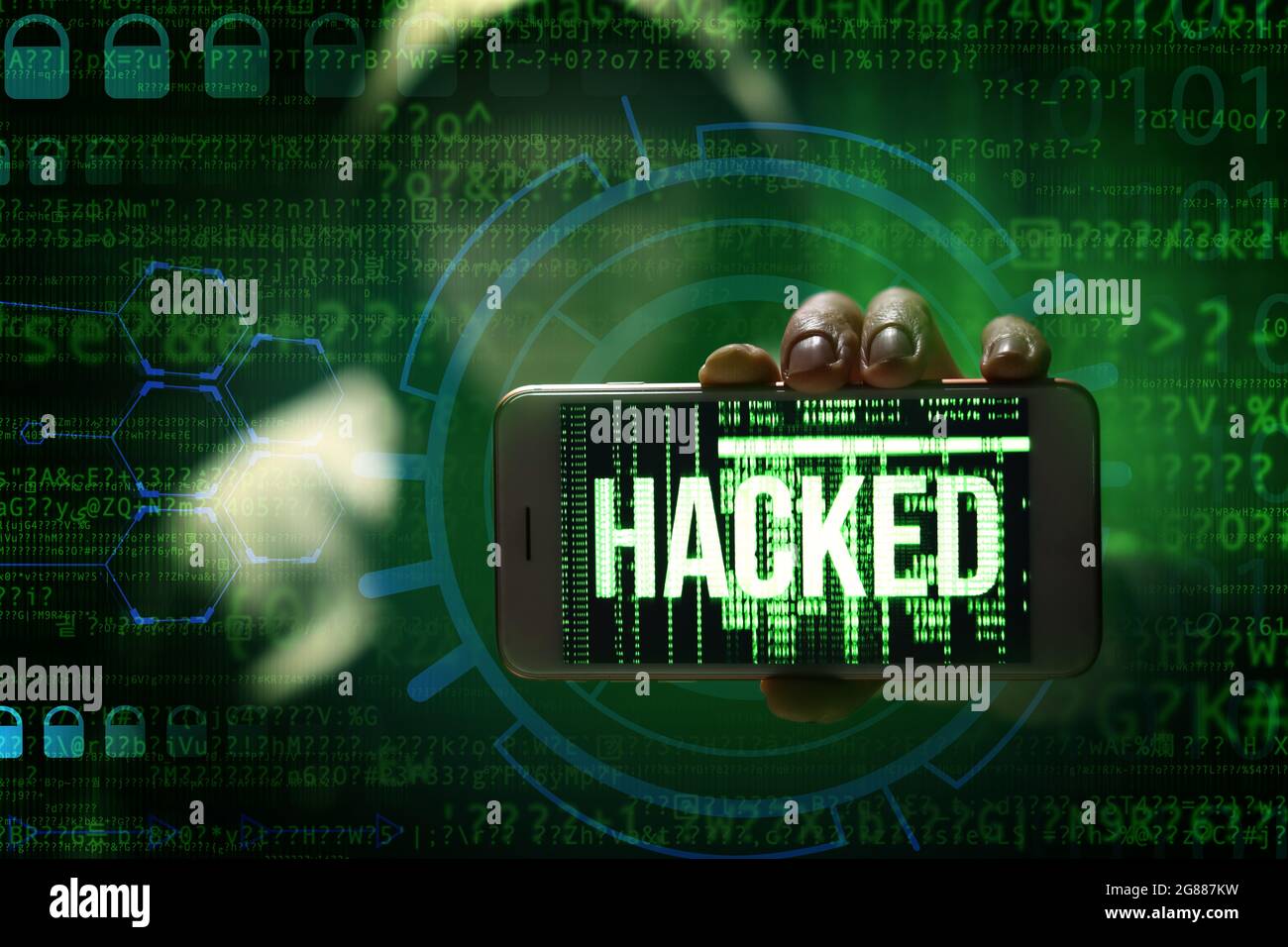 Hacker holding mobile phone with word HACKED on screen against dark ...