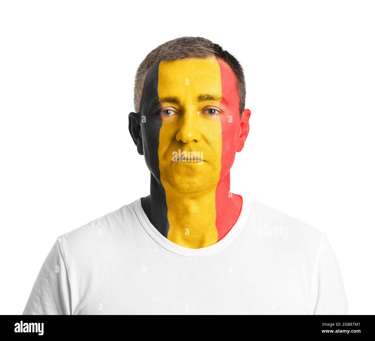 Mature man with face in colors of Belgian flag on white background ...