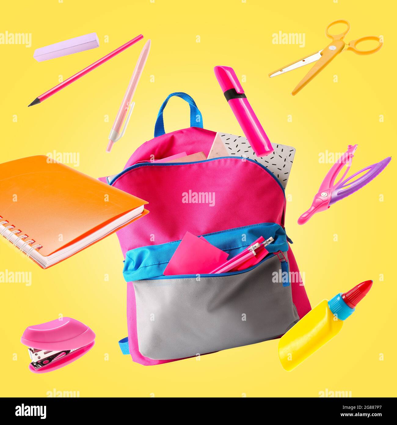 Flying backpack with school supplies on color background Stock Photo ...