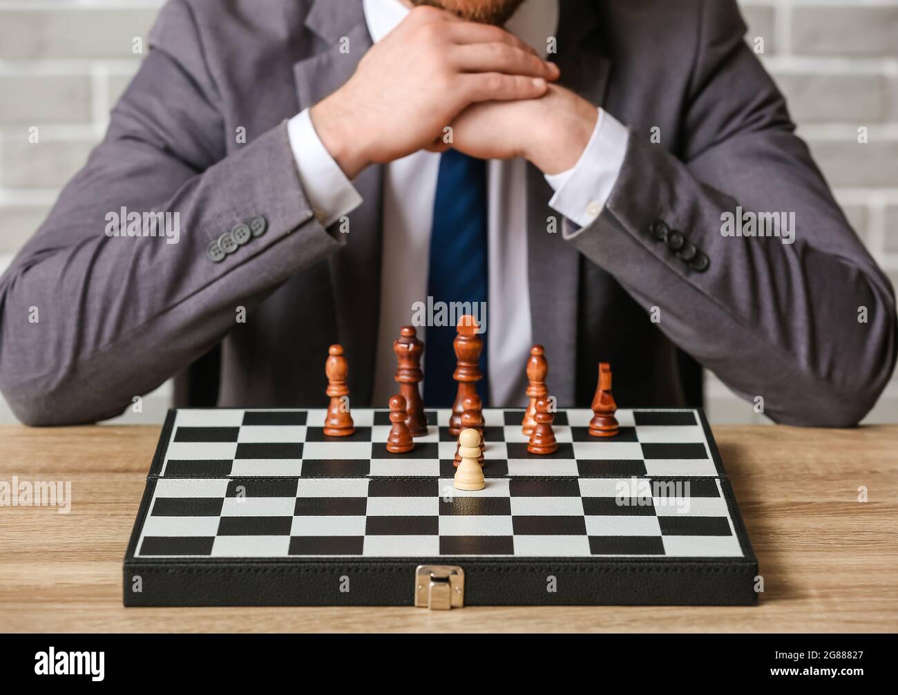 Man playing chess on wooden table, closeup Stock Photo - Alamy