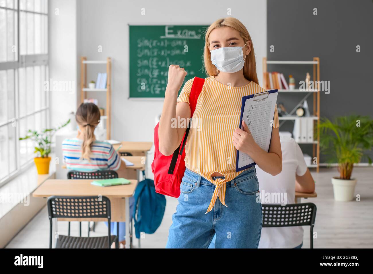 Happy student after passing school test in classroom Stock Photo - Alamy