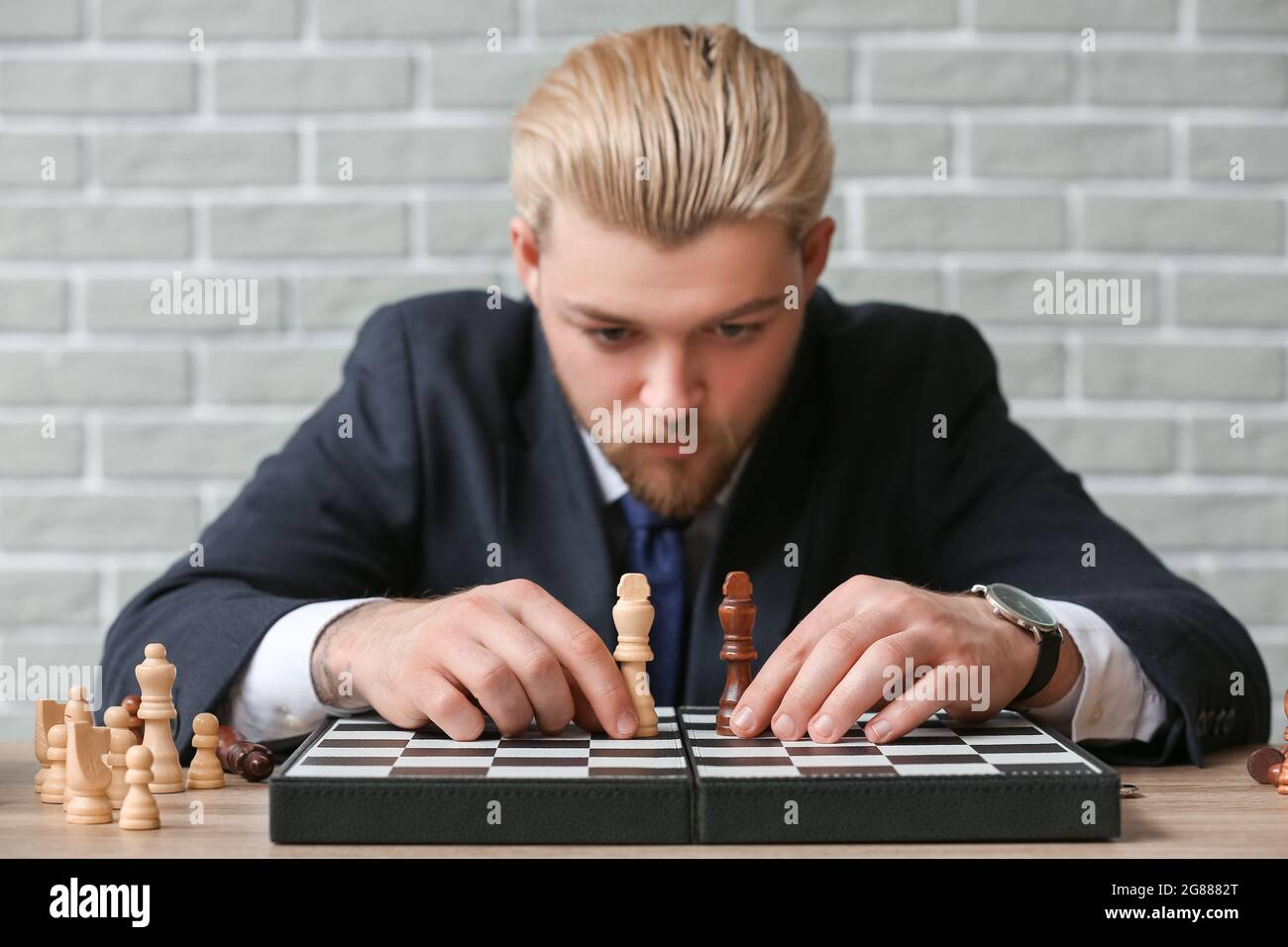 Man with chess pieces on game board, closeup Stock Photo - Alamy