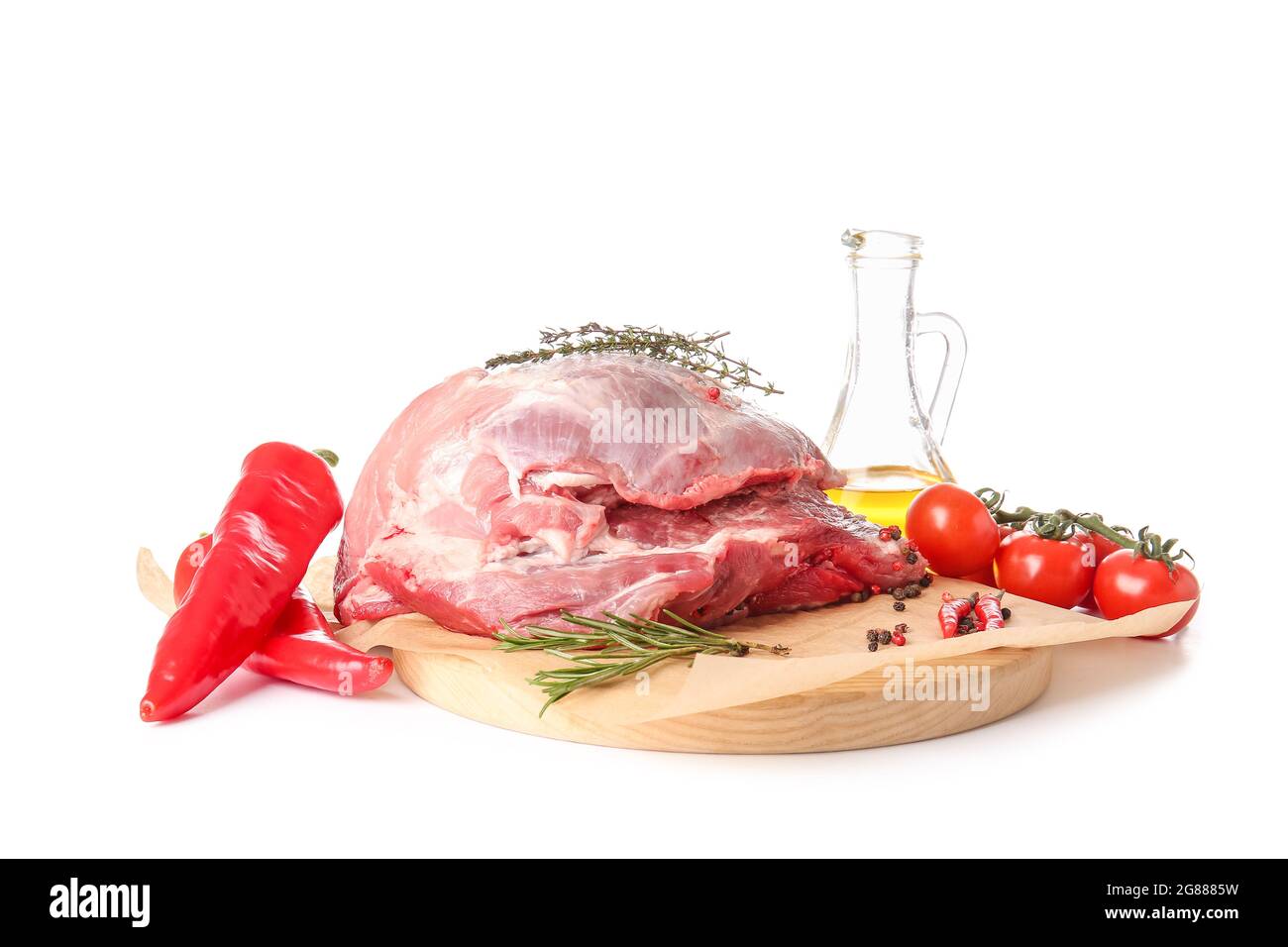 Board with raw pork meat, spices and vegetables on white background ...