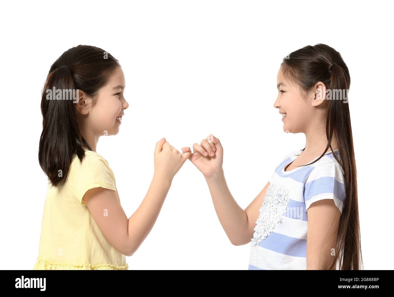 Cute Asian sisters making pinky promise on white background Stock Photo ...