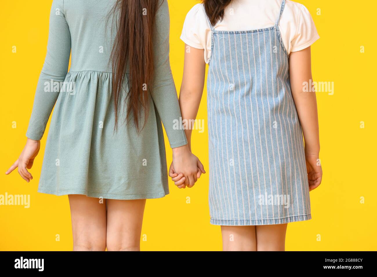 Cute little girls on color background Stock Photo - Alamy