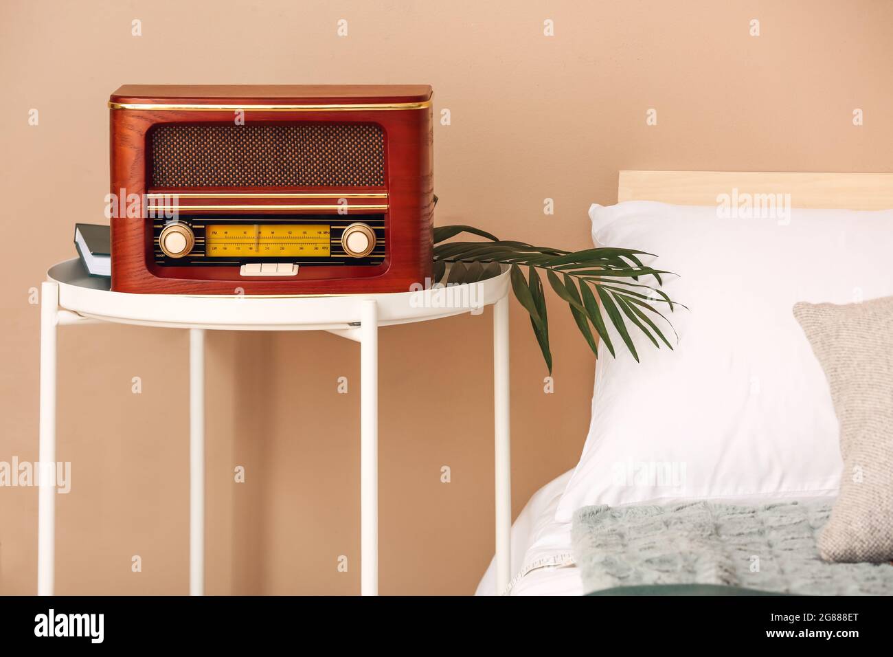 Retro radio receiver on table in bedroom Stock Photo - Alamy