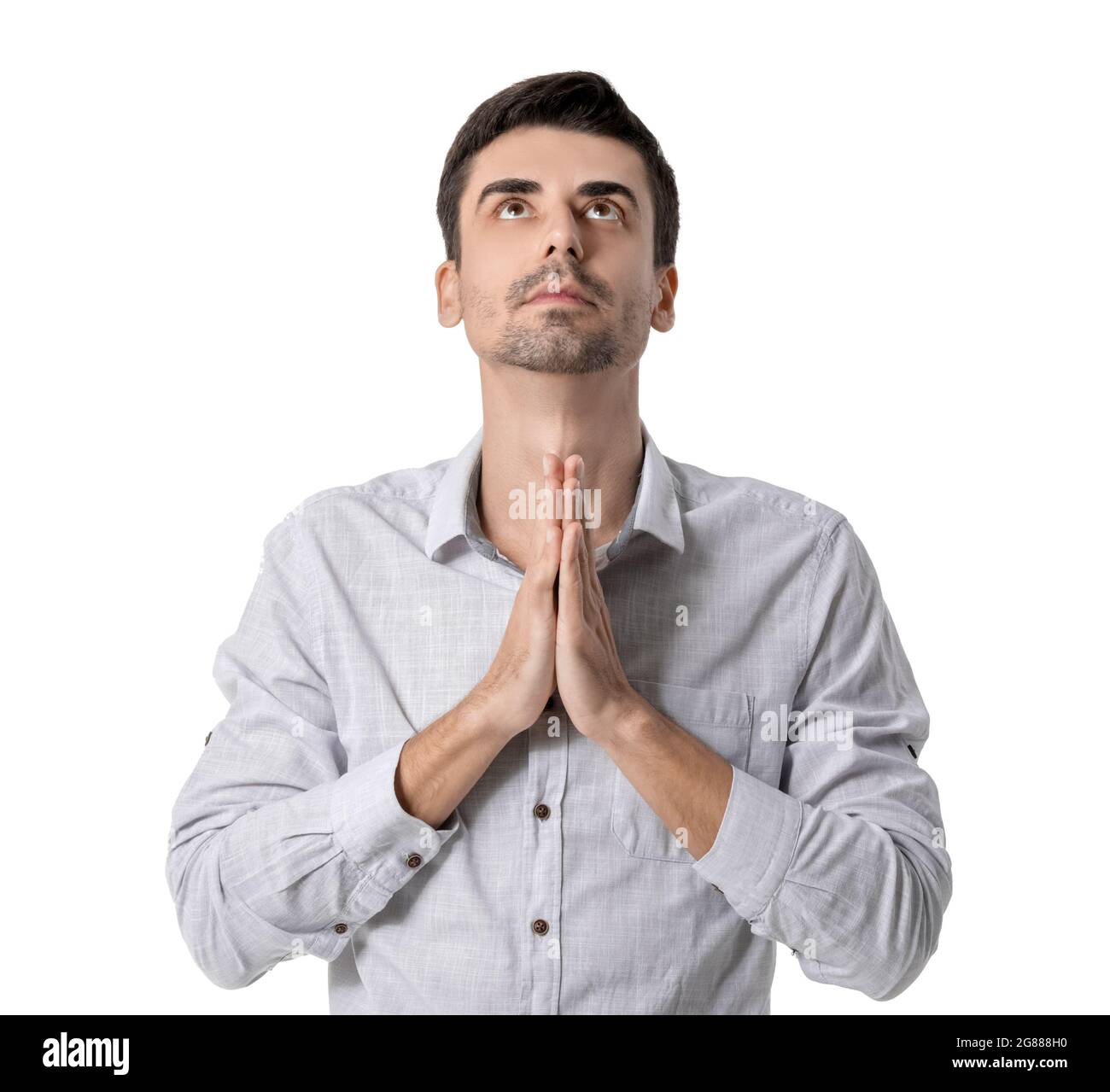 Religious young man praying on white background Stock Photo - Alamy