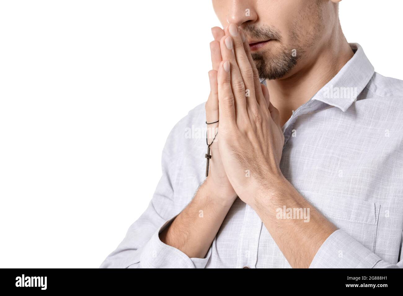 Religious young man praying on white background Stock Photo - Alamy