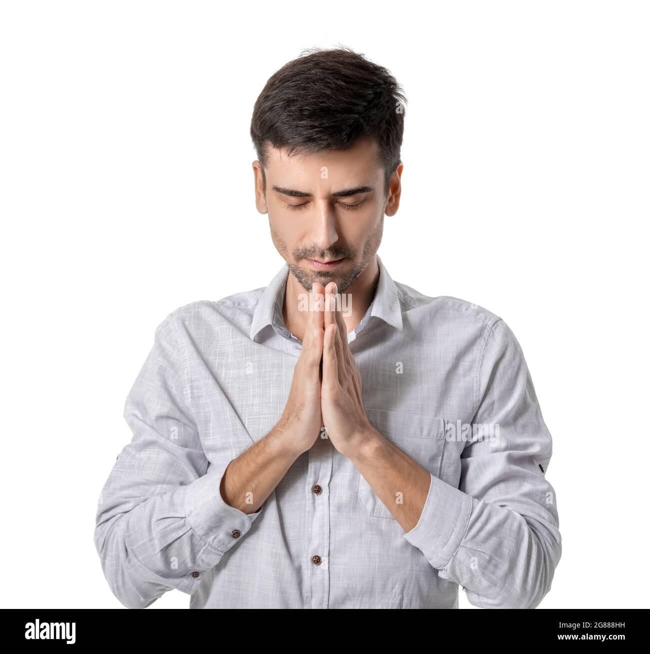 Religious young man praying on white background Stock Photo - Alamy