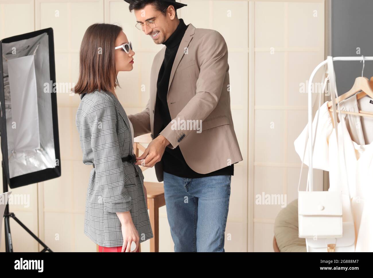 Male stylist working with model in studio Stock Photo - Alamy