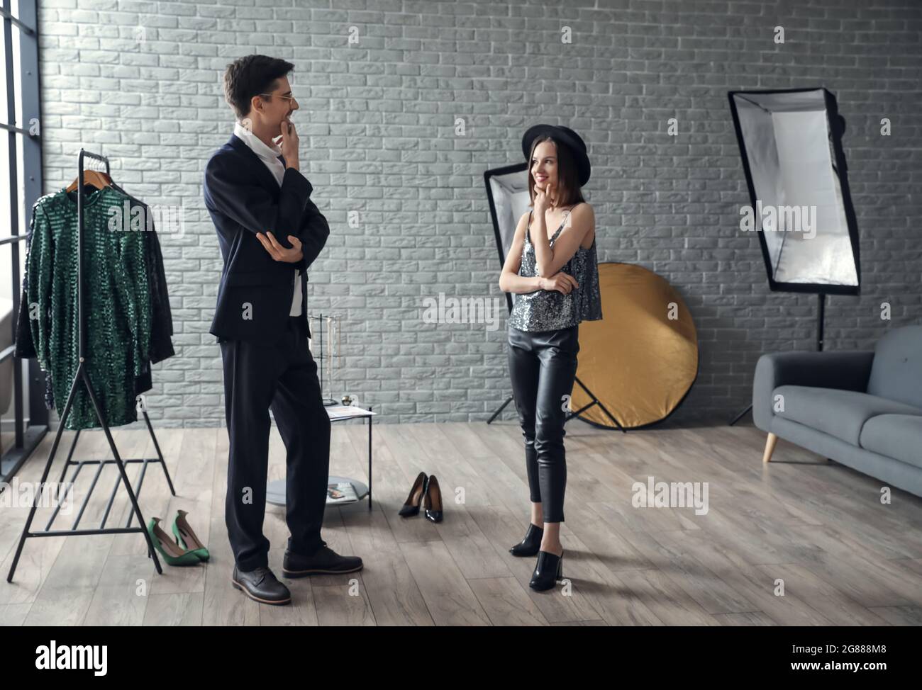 Male stylist working with model in studio Stock Photo - Alamy
