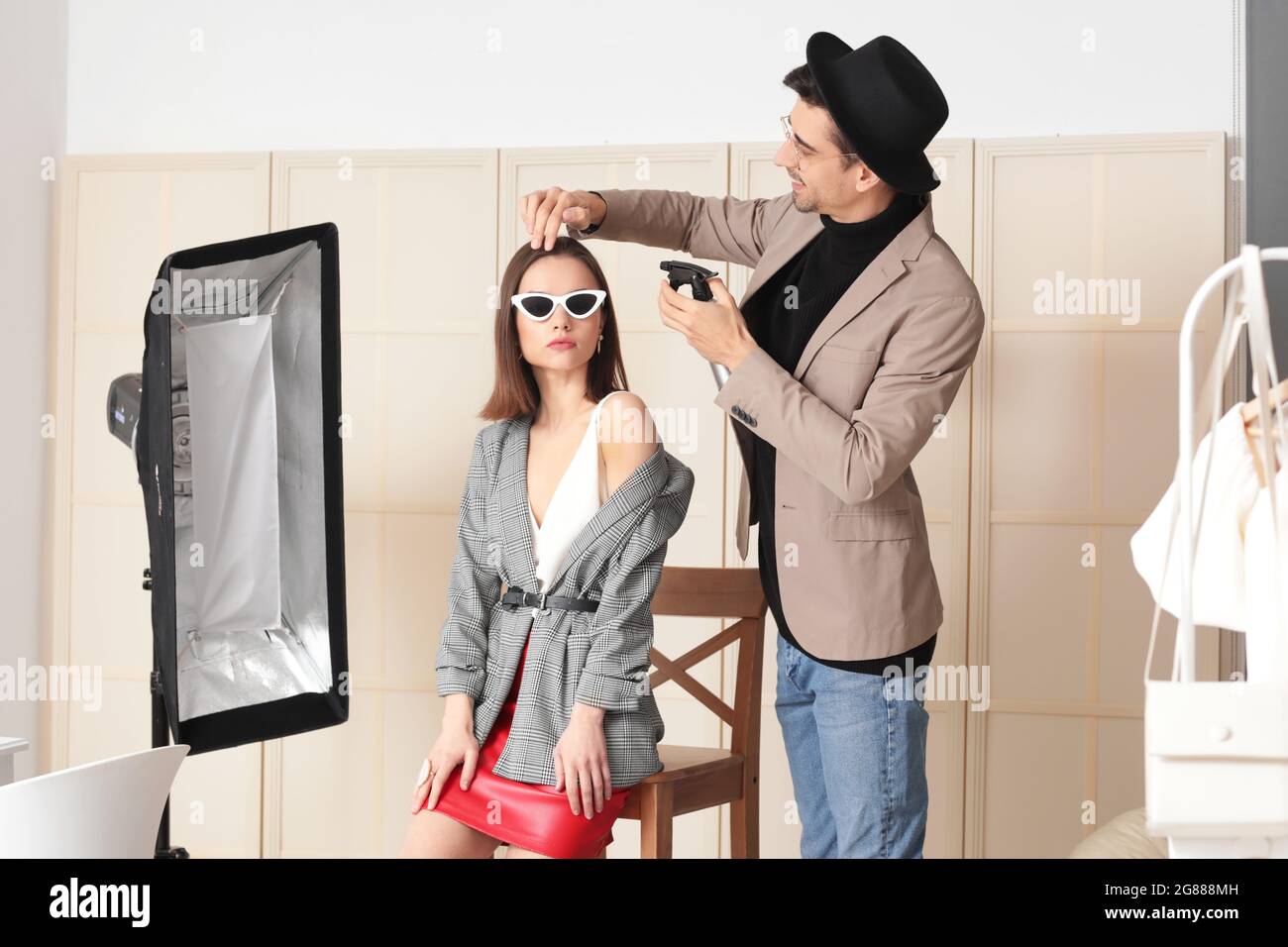Male stylist working with model in studio Stock Photo - Alamy