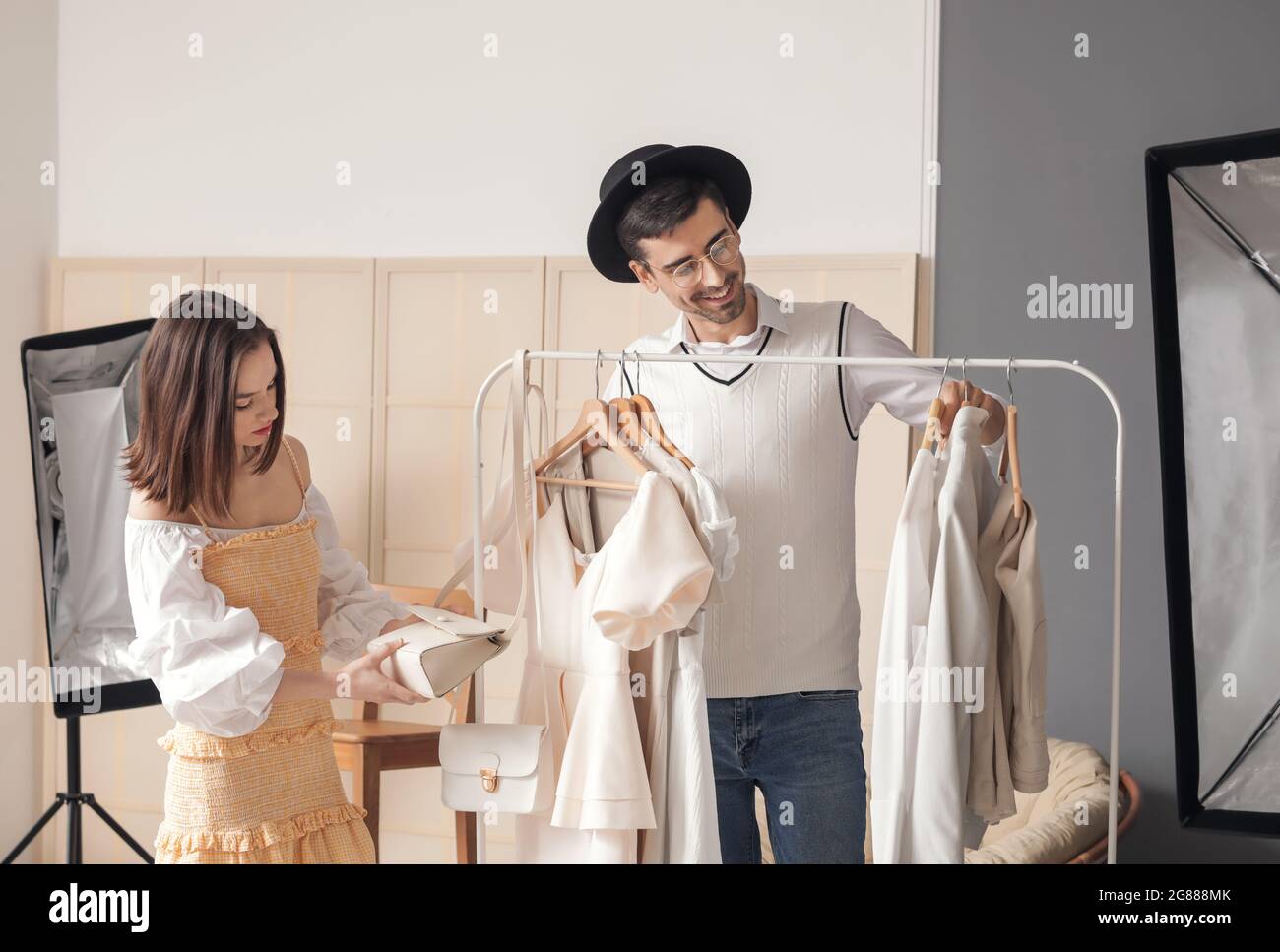 Male stylist working with model in studio Stock Photo - Alamy