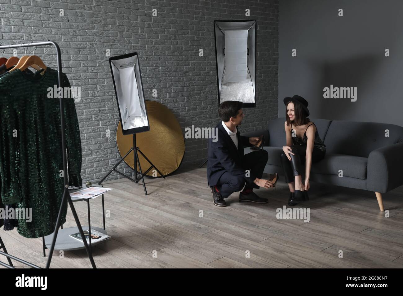 Male stylist working with model in studio Stock Photo - Alamy