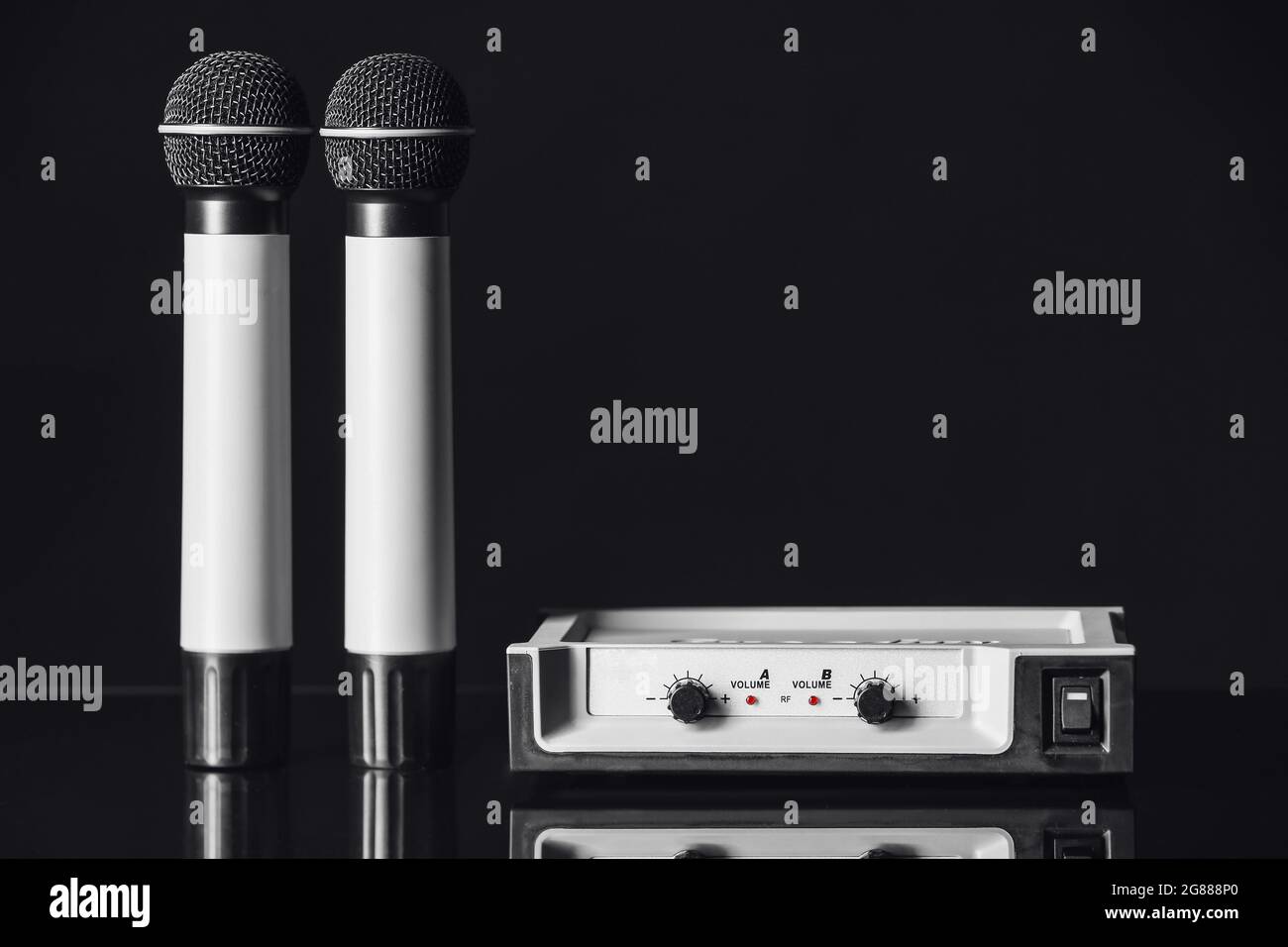 Modern microphones and audio system on dark background Stock Photo - Alamy