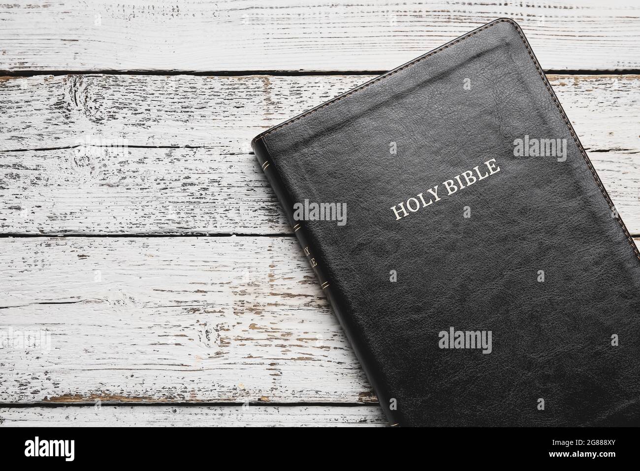 Holy Bible on light wooden background Stock Photo - Alamy