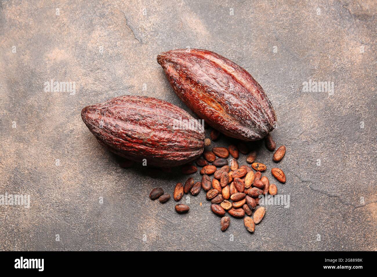 Fresh cocoa fruits and beans on grunge background Stock Photo - Alamy