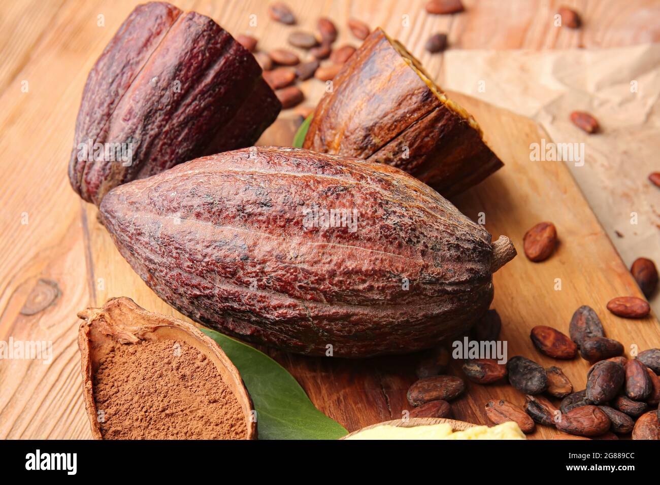 Fresh cocoa fruits, beans and powder on wooden background Stock Photo ...
