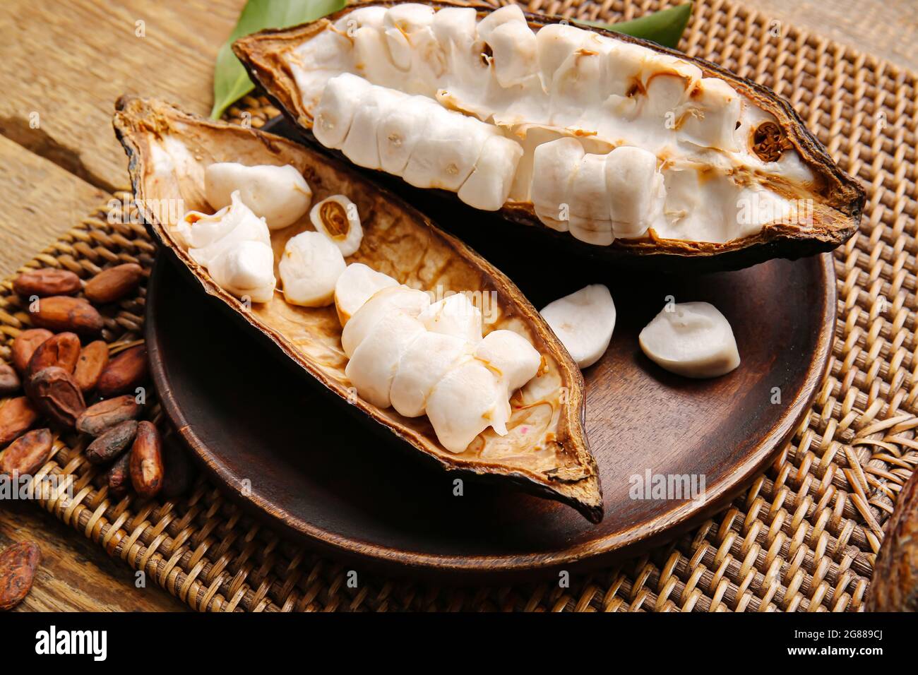 Plate with fresh cocoa fruit on wooden background Stock Photo - Alamy