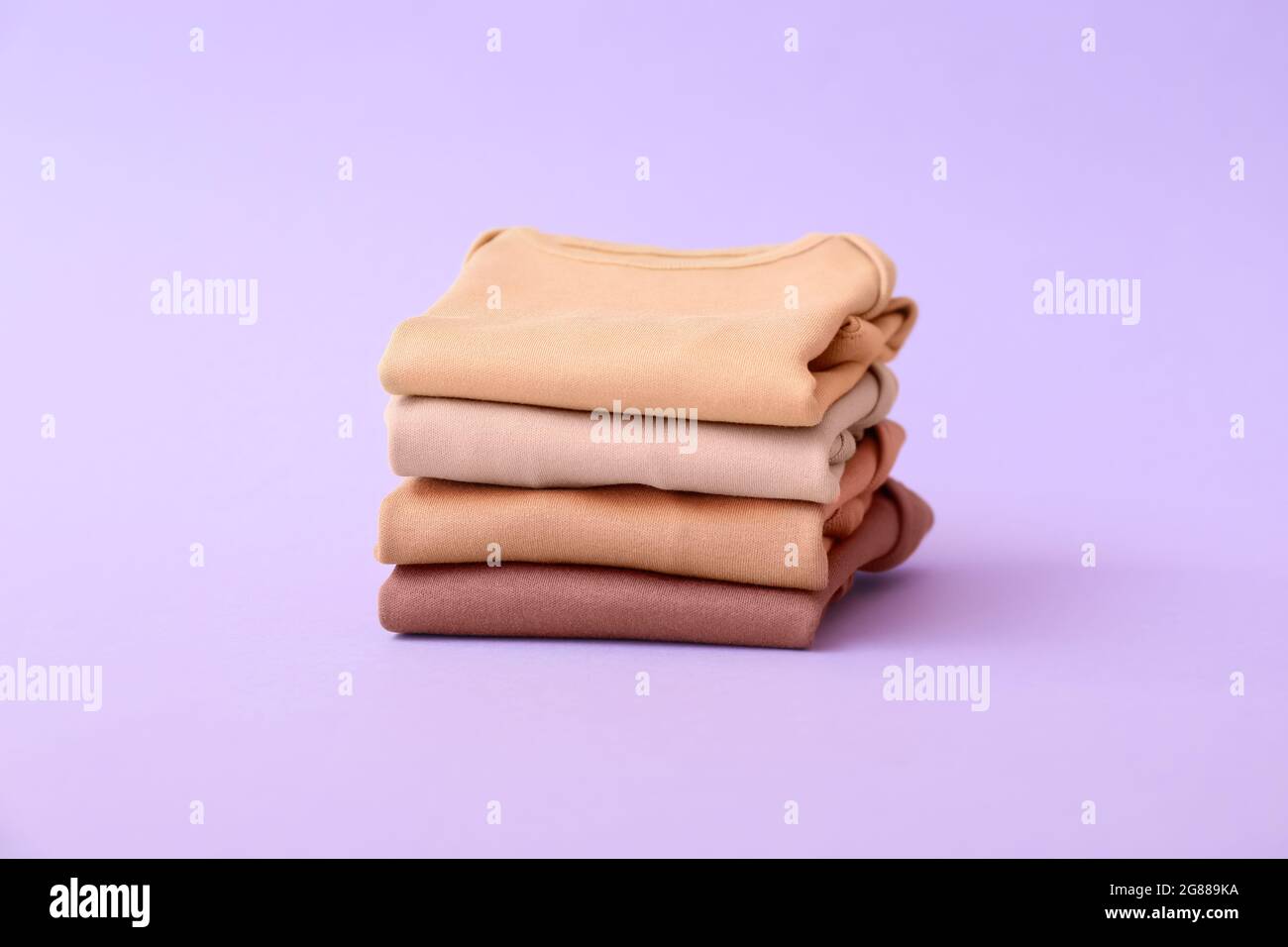 Stack of baby clothes on color background Stock Photo - Alamy